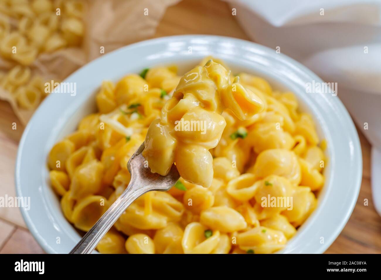 Delicious macaroni and cheddar cheese shell noodles in a bowl Stock ...