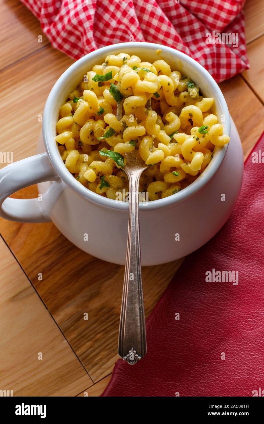 Delicious macaroni and cheddar cheese cellentani pasta in a bowl Stock ...