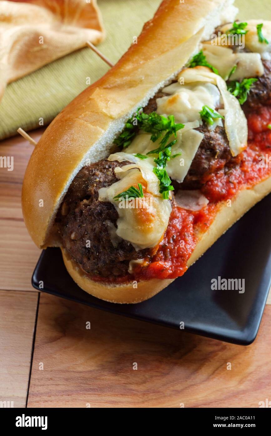 Italian meatball parmesan hero sandwich on a torpedo roll with parsley ...