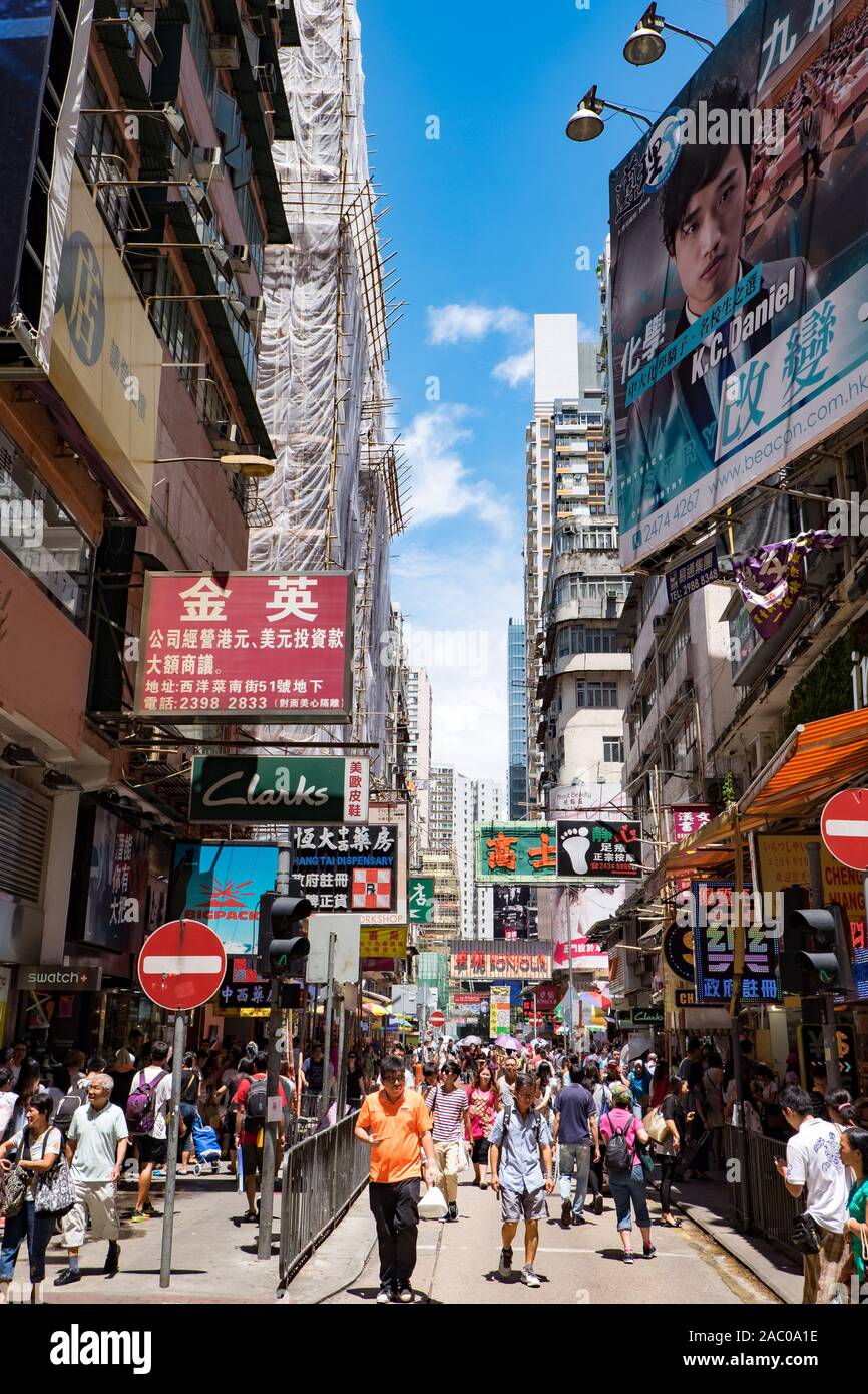 Shoppers browse the bustling street market in Hong Kong, surrounded by ...