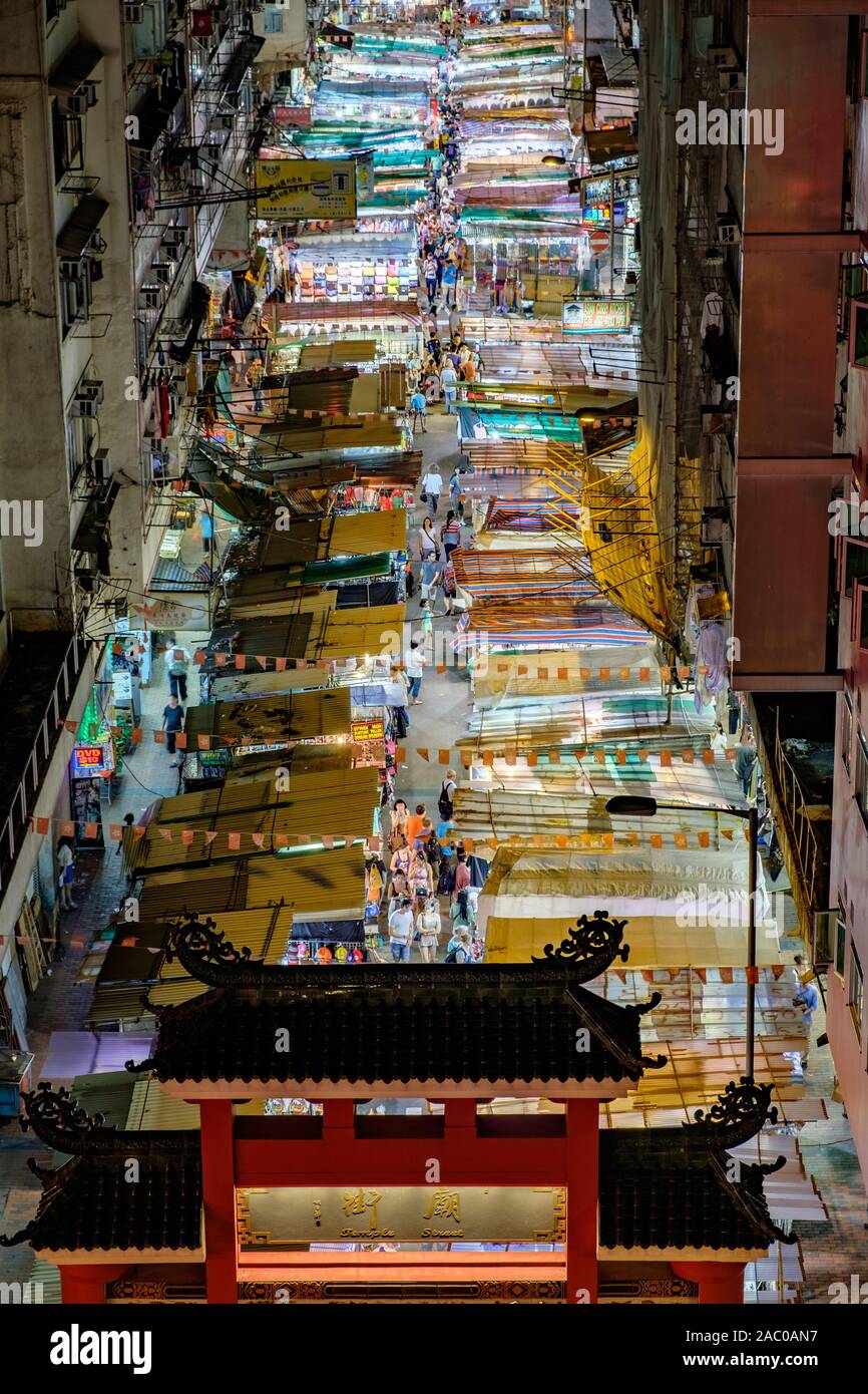 Shoppers browse the vibrant Temple Street Night Market in Hong Kong, seeking bargains and ...