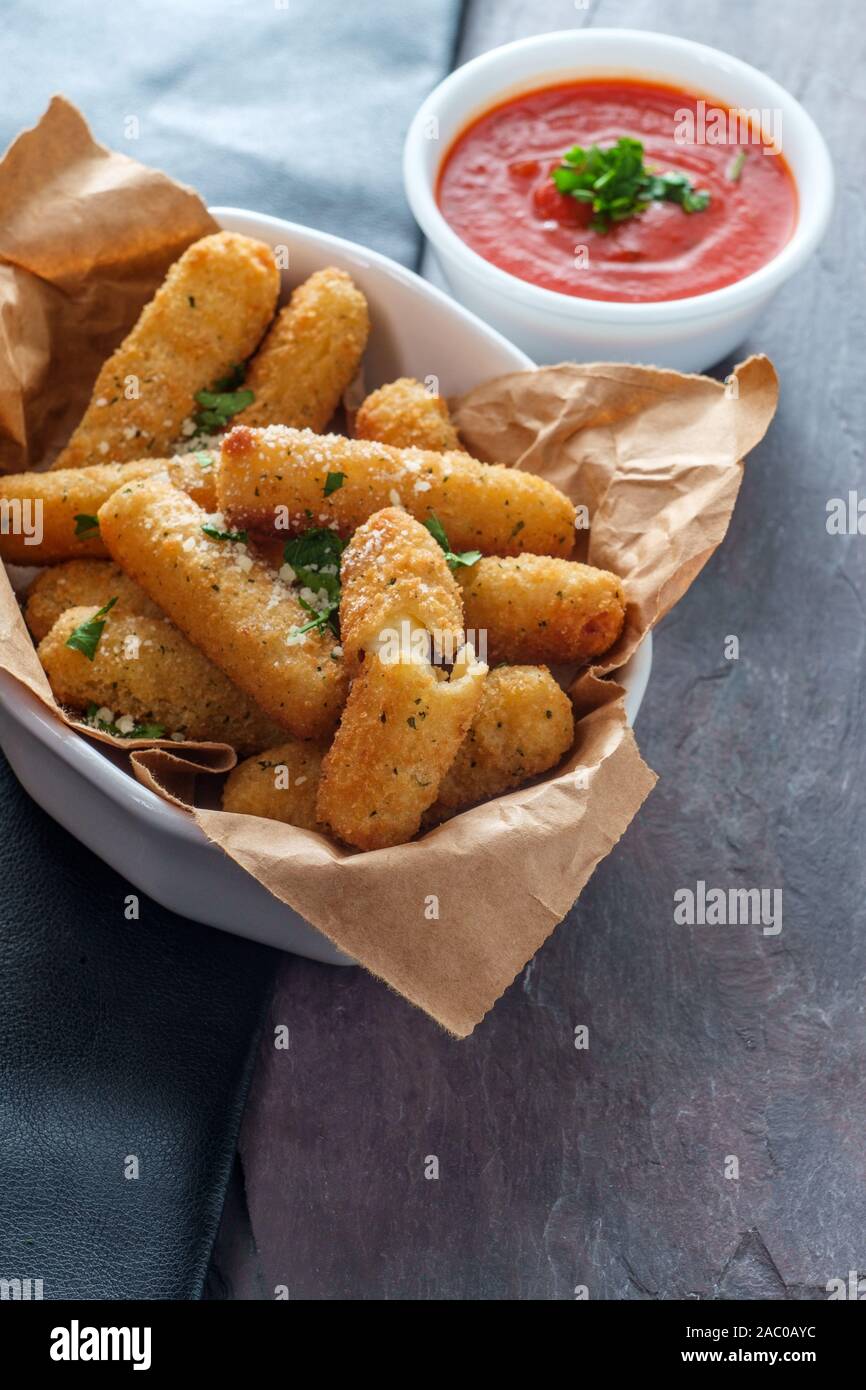 Breaded fried mozzarella cheese sticks with tomato marinara dipping ...