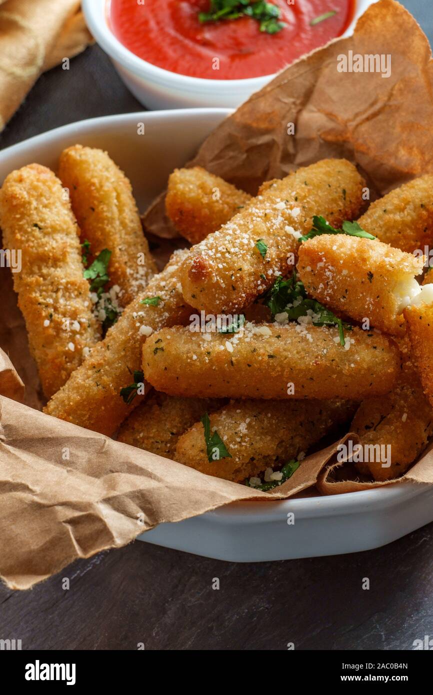 Breaded fried mozzarella cheese sticks with tomato marinara dipping ...