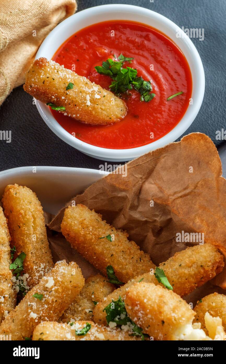 Breaded fried mozzarella cheese sticks with tomato marinara dipping ...