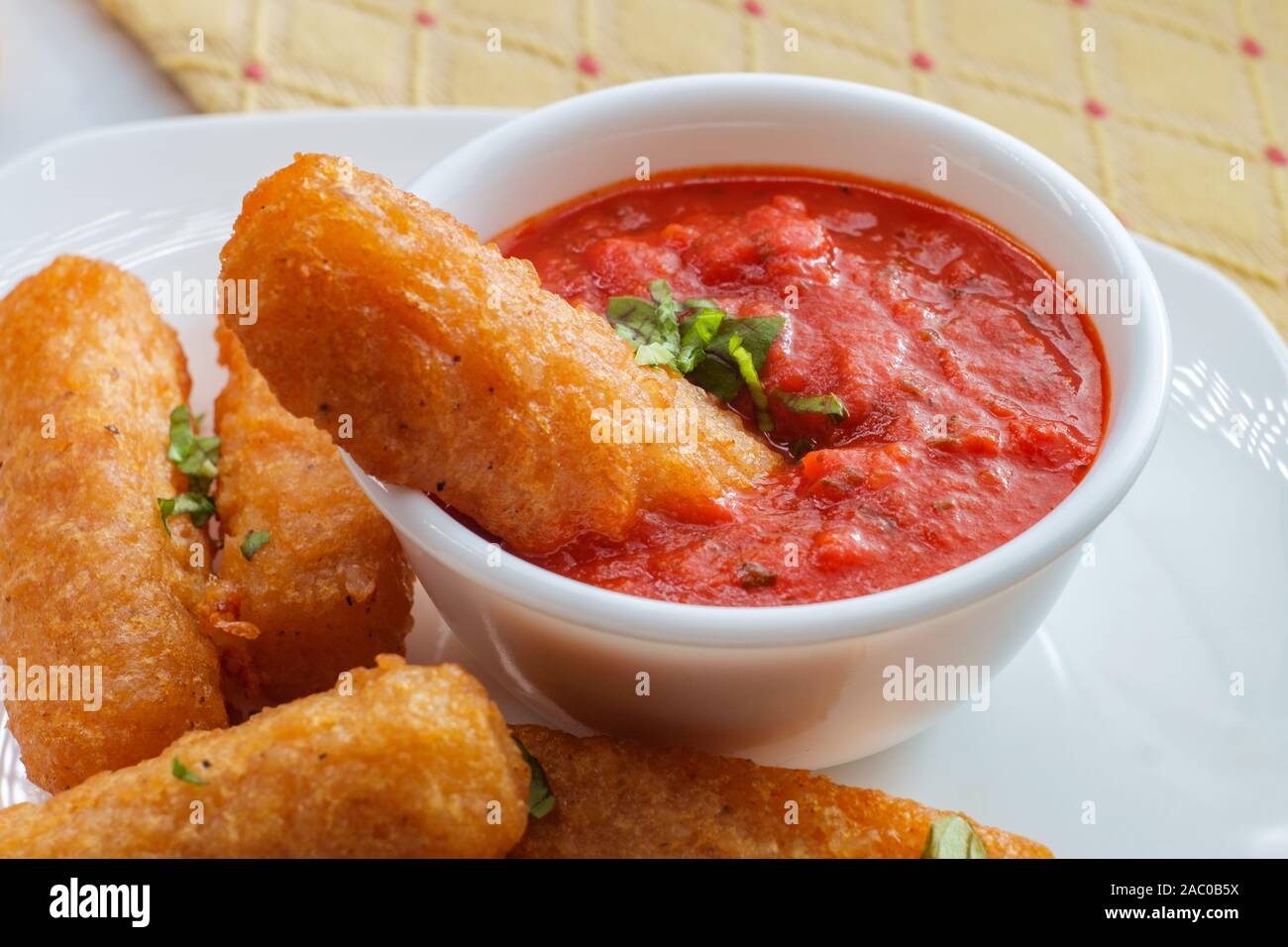 Breaded fried mozzarella cheese sticks with tomato marinara dipping ...