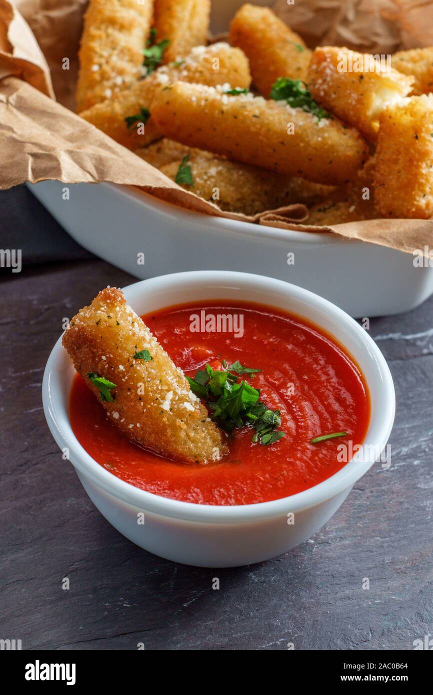 Breaded fried mozzarella cheese sticks with tomato marinara dipping ...