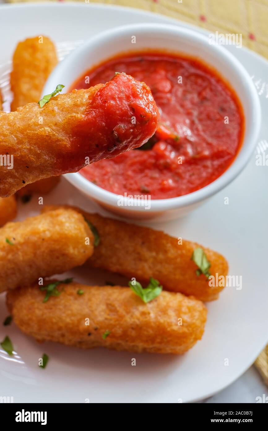 Breaded fried mozzarella cheese sticks with tomato marinara dipping ...