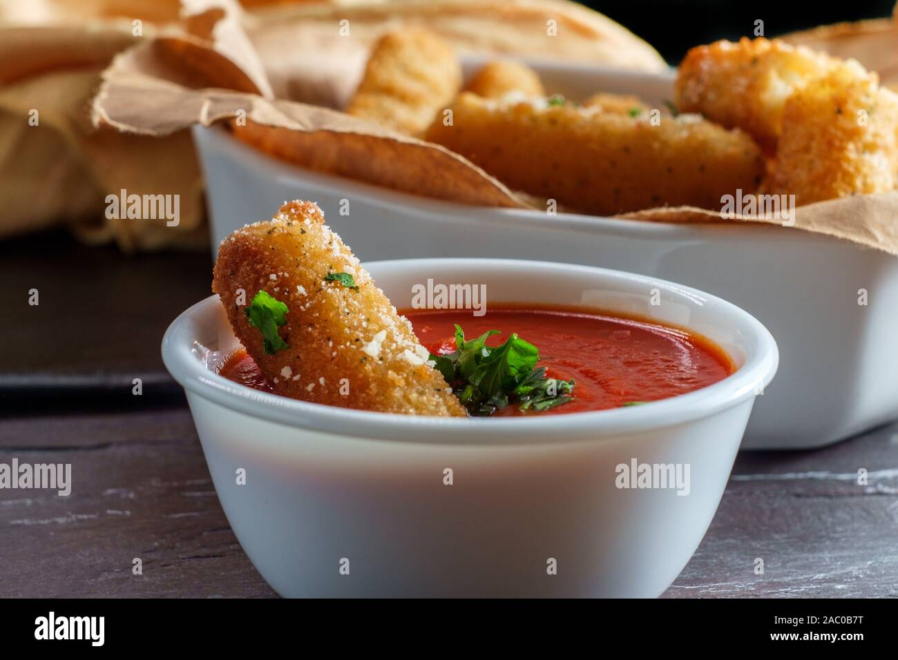 Breaded fried mozzarella cheese sticks with tomato marinara dipping ...