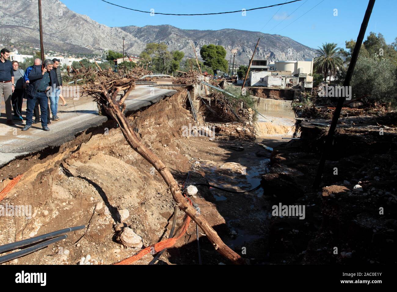 A road is covered with mud after storms in Kineta village, about 68 ...