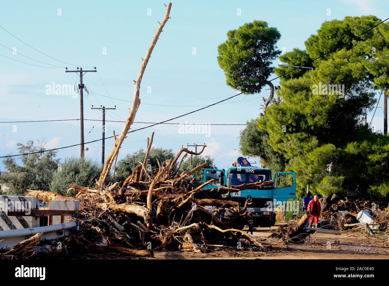 The road is covered with mud after storms in Kineta village, about 68 ...