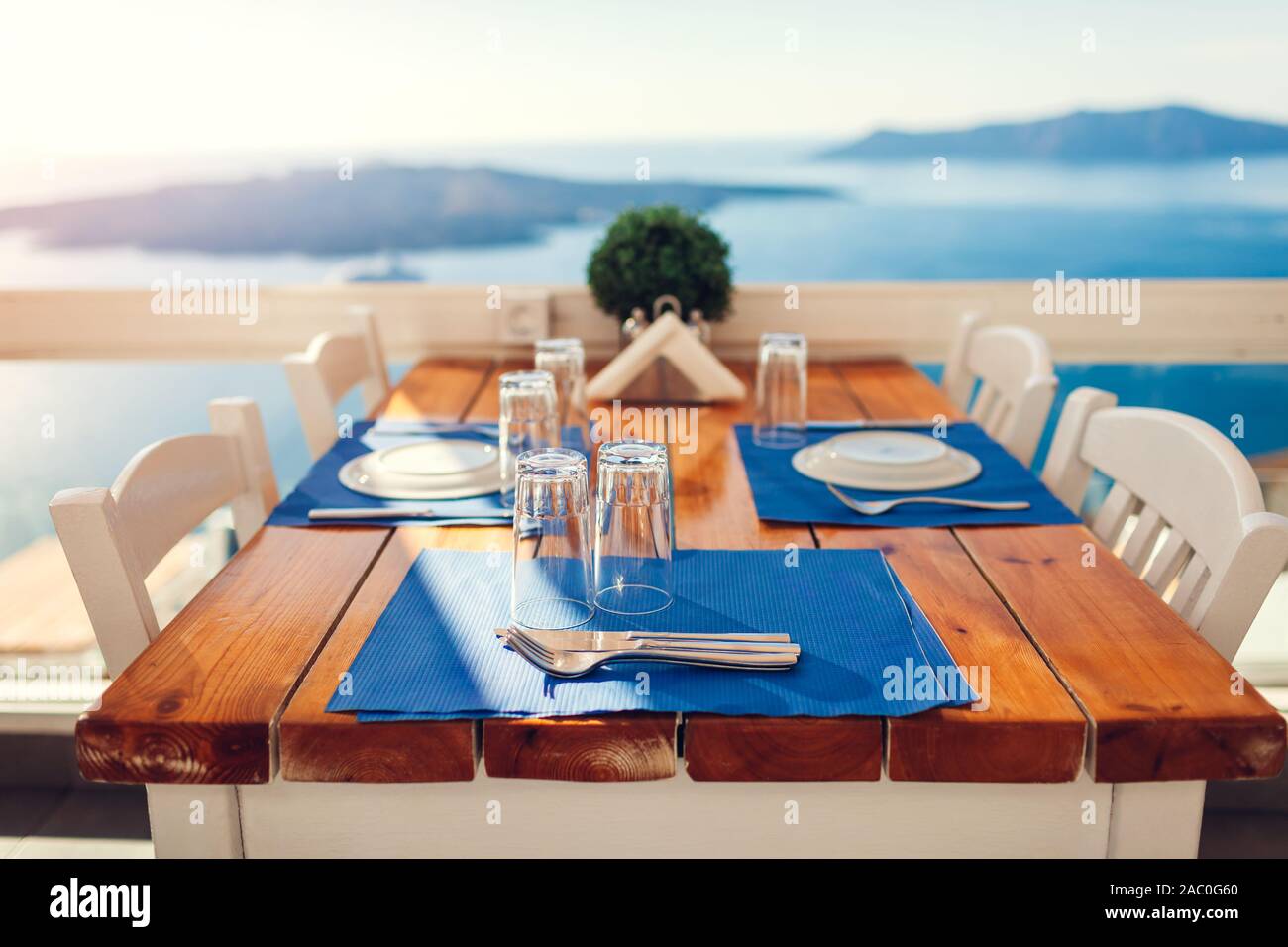 Santorini caldera view restaurant table and chairs hi-res stock ...