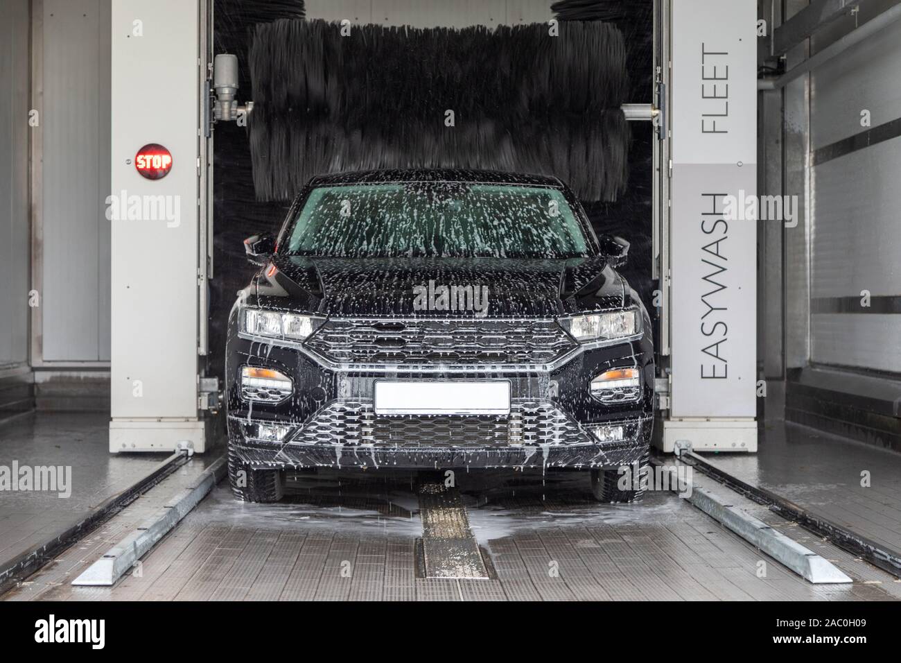 a black car stands in a car wash and is washed Stock Photo - Alamy