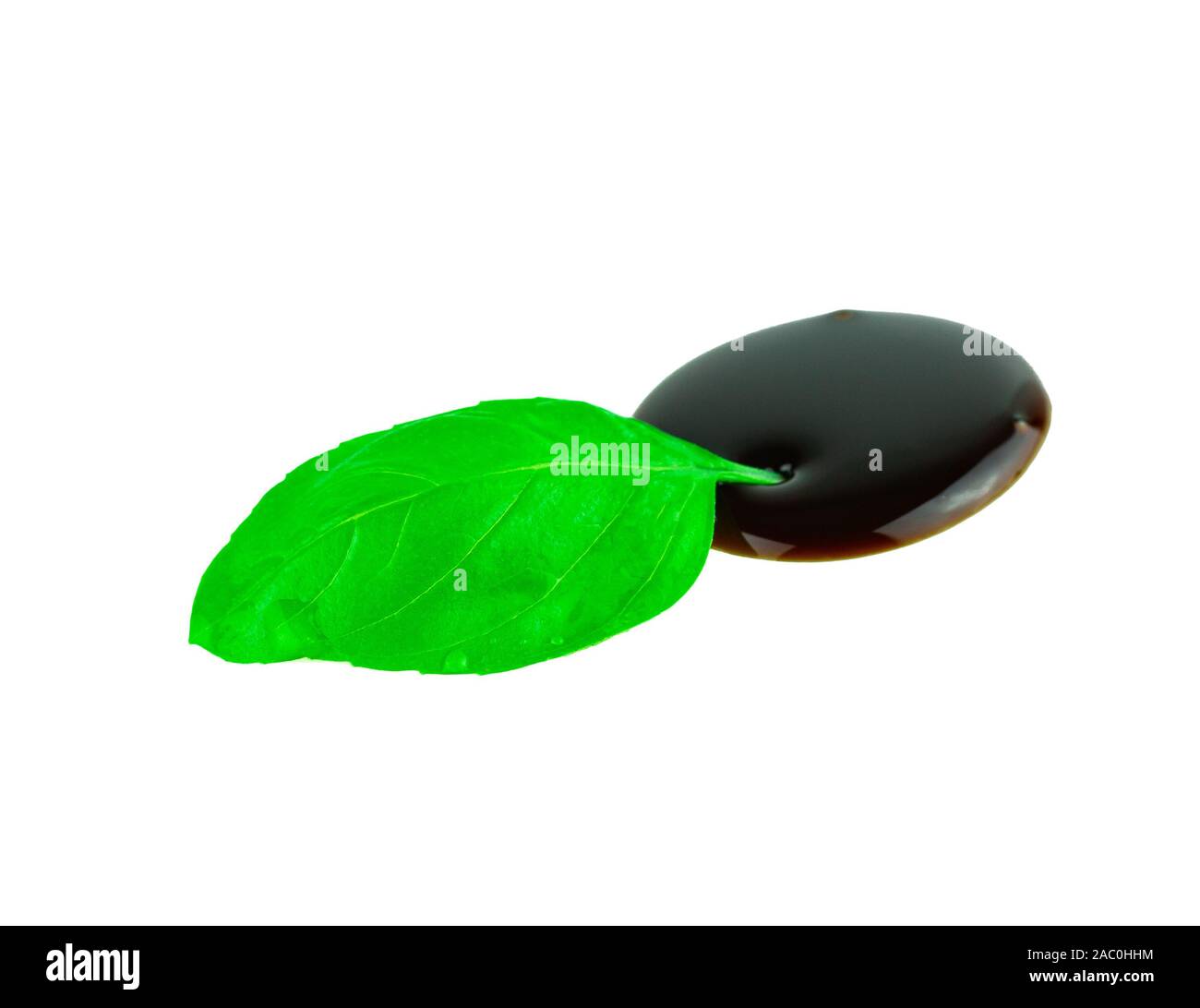 Basil leaf with balsamic vinegar drops on white. Italian food cuisine ...