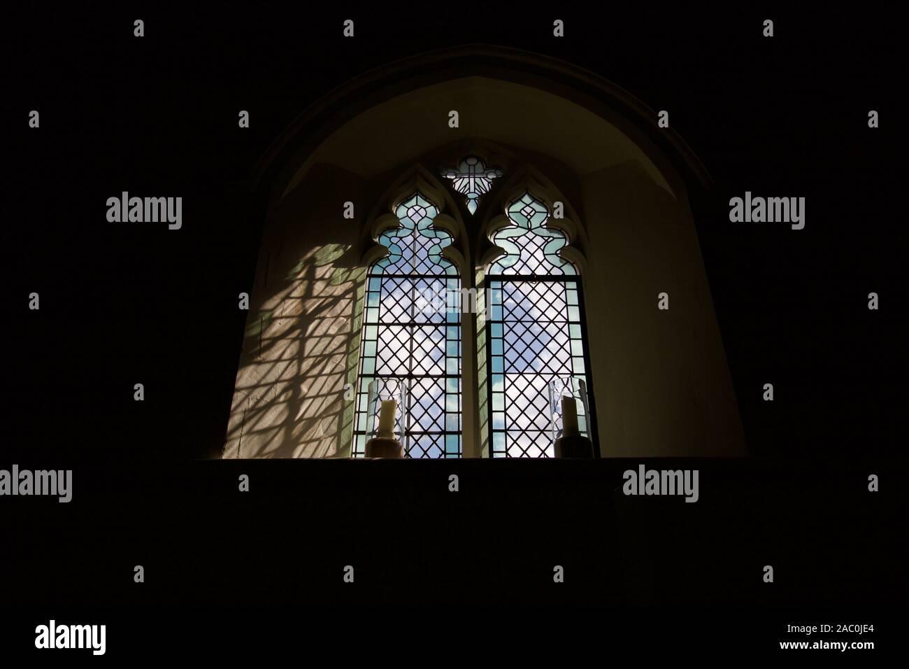 Light shining through Christian church glass window Stock Photo - Alamy