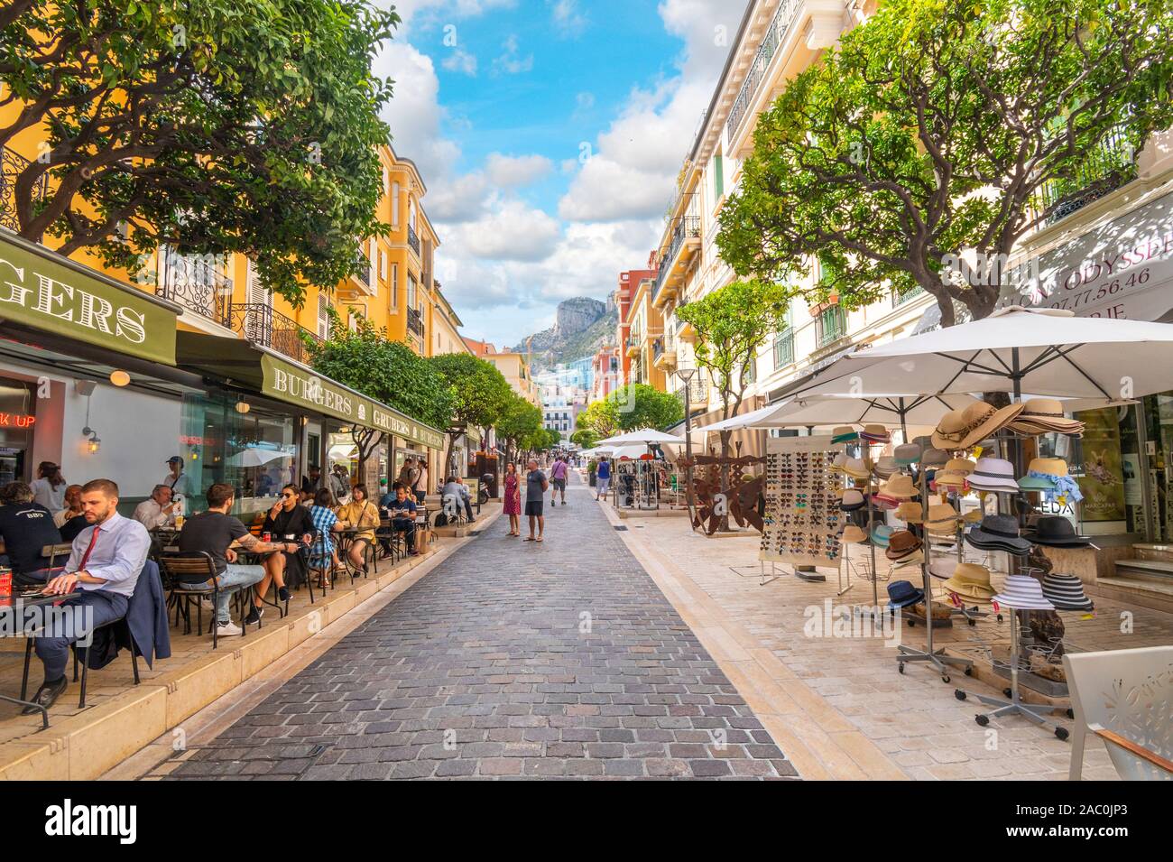 Tourists and local Monegasque enjoy a sunny summer day shopping and ...