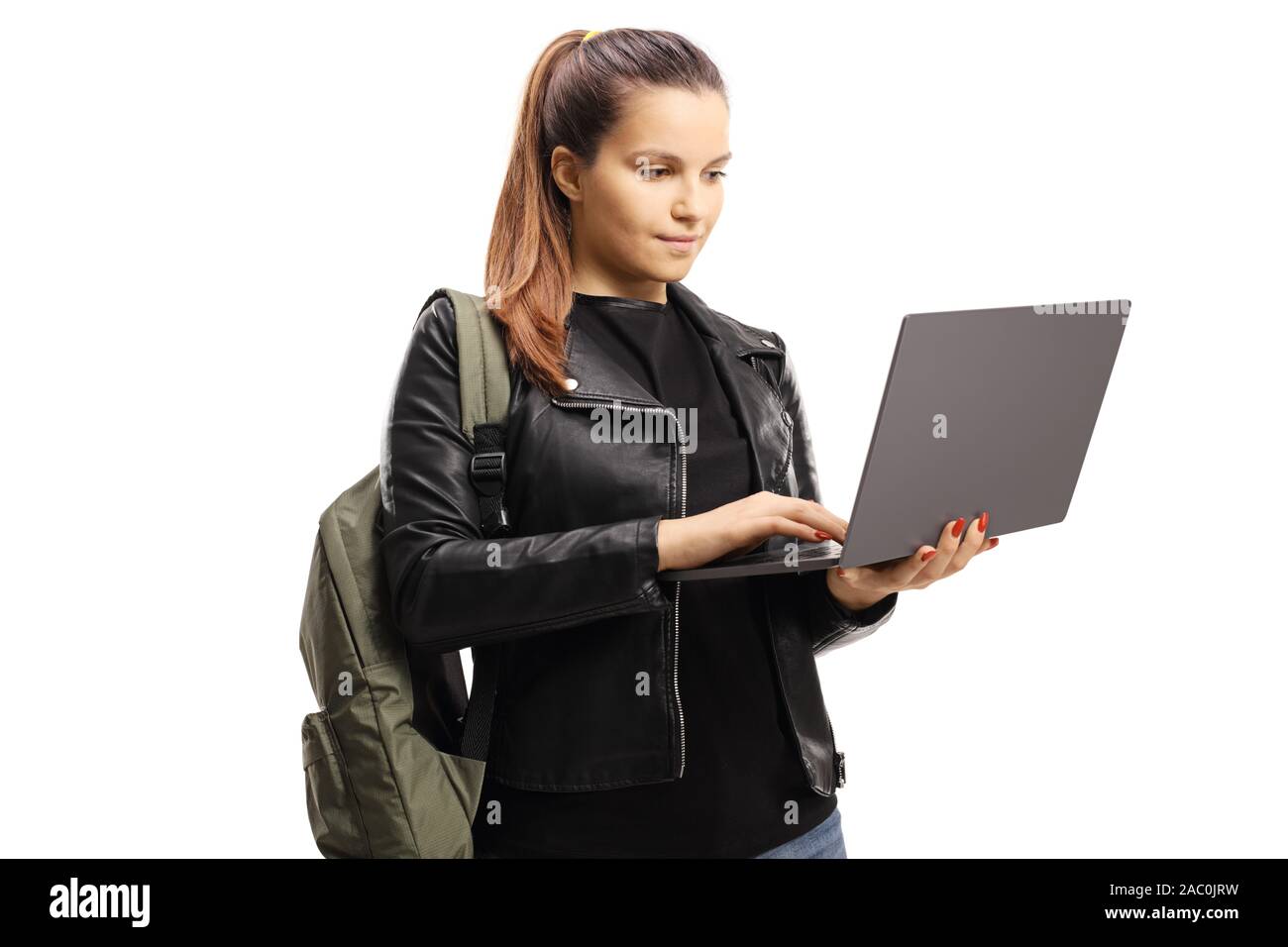 Female student standing and using a laptop computer isolated on white ...
