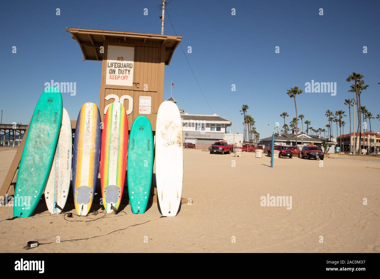 Line of surfboards standing against a lifeguard hut Newport pier Balboa ...