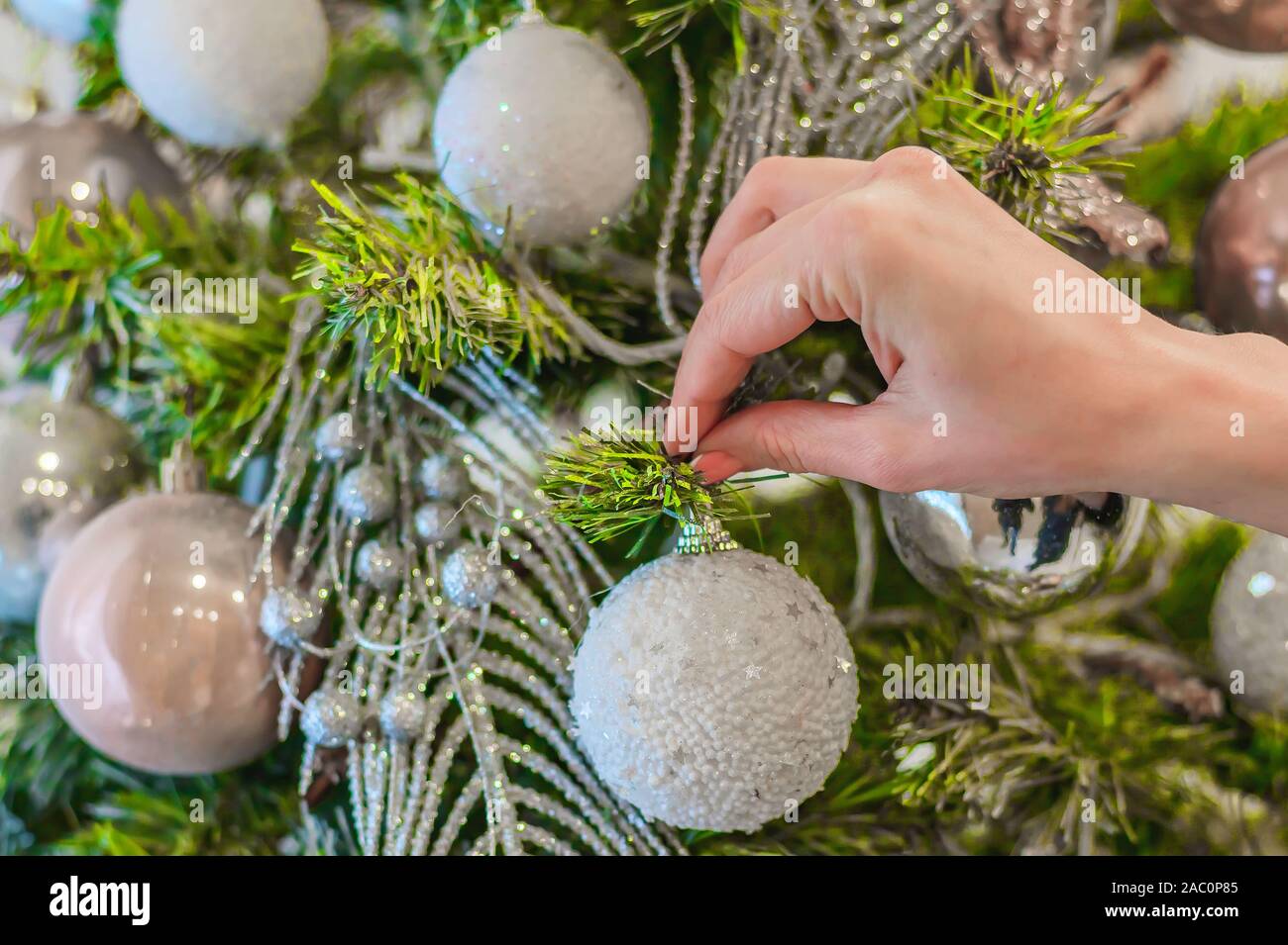 Hand person decorates christmas tree hi-res stock photography and ...