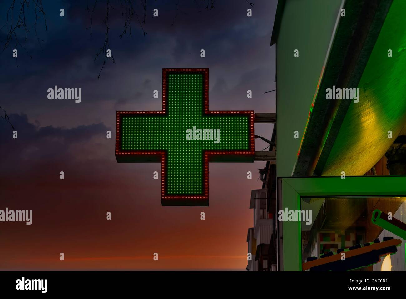 LED pharmacy sign on a colorful sunset background. 24 hour pharmacy ...