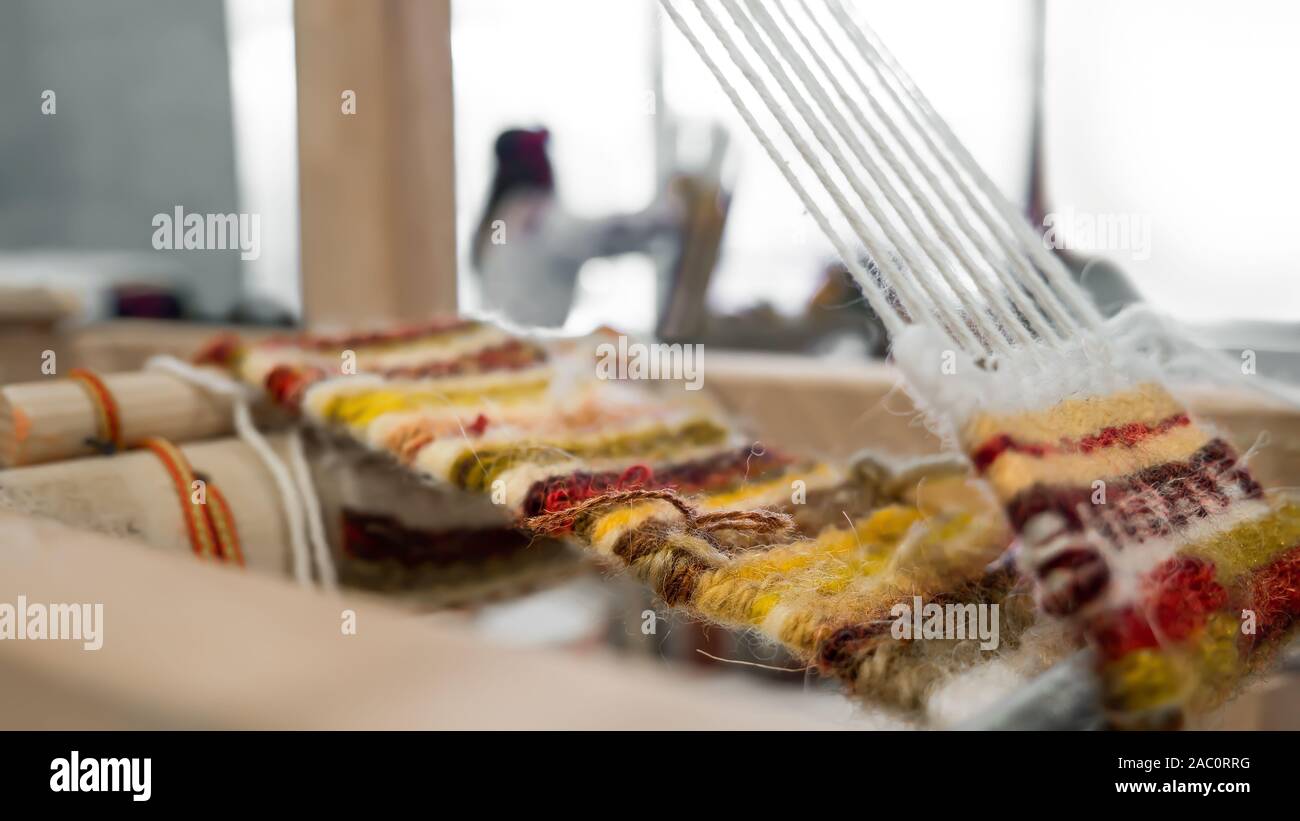 Detail of traditional vintage weaving hand loom with wool close up. the ...