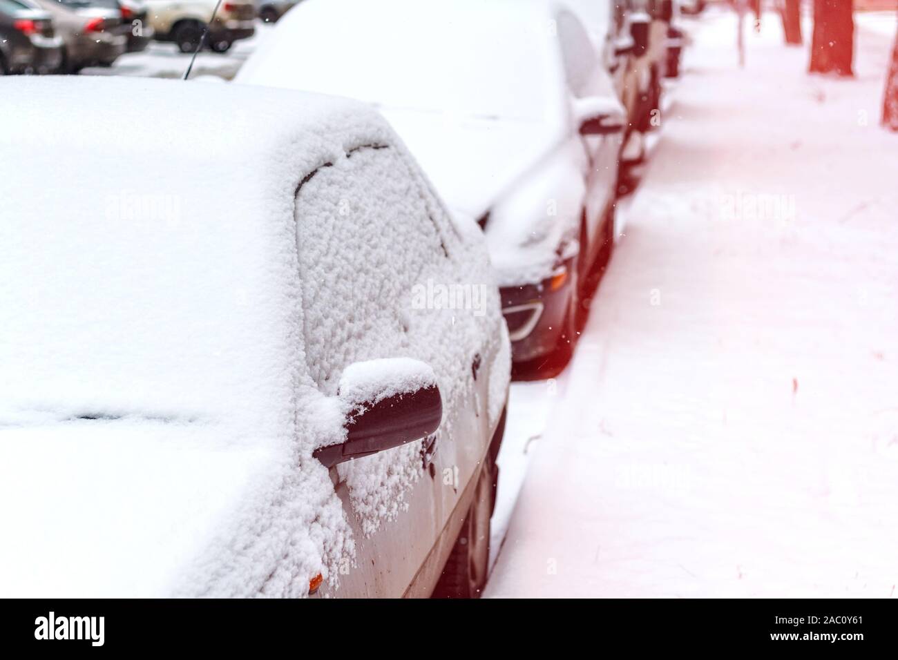 Snow on cars after snowfall. Winter urban scene. Toned Stock Photo - Alamy