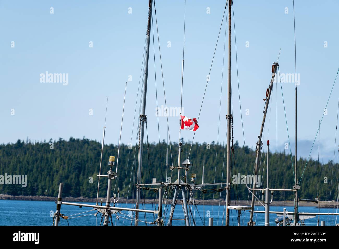 The Canadian flag on the mast of a fishing boat in Price Rupert ...