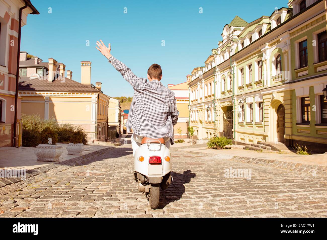 Rear view of the scooter driver Stock Photo - Alamy