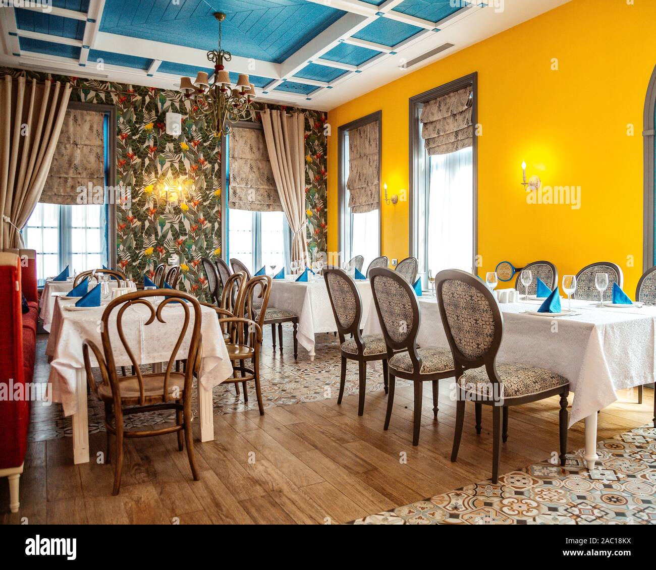 restaurant hall with yellow wall and classic furniture Stock Photo - Alamy