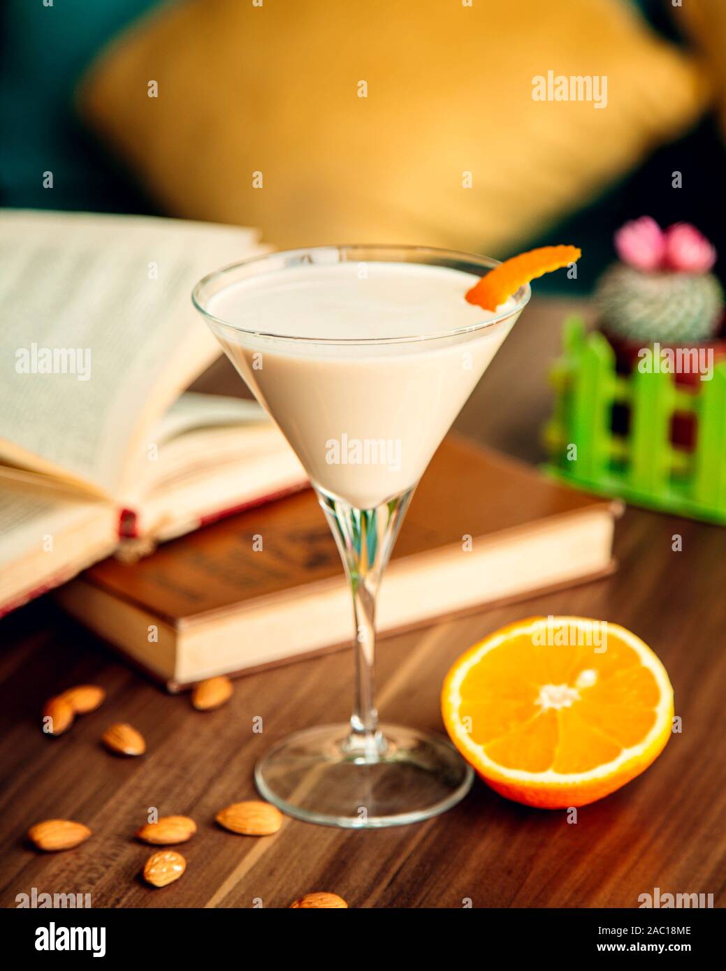 milky cocktail garnished with orange zest in martini glass Stock Photo ...