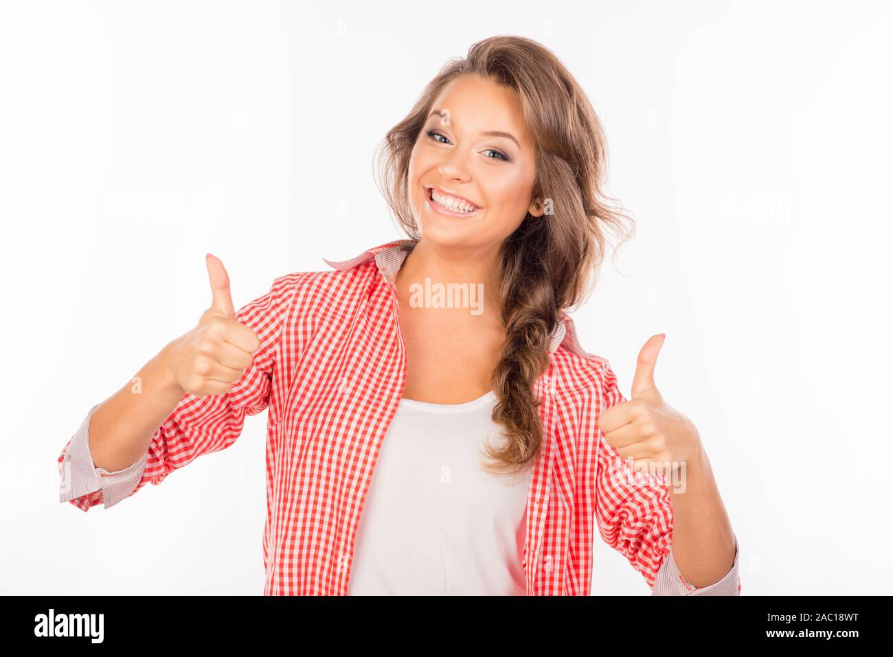 Happy girl showing thumbs up and smiling Stock Photo - Alamy