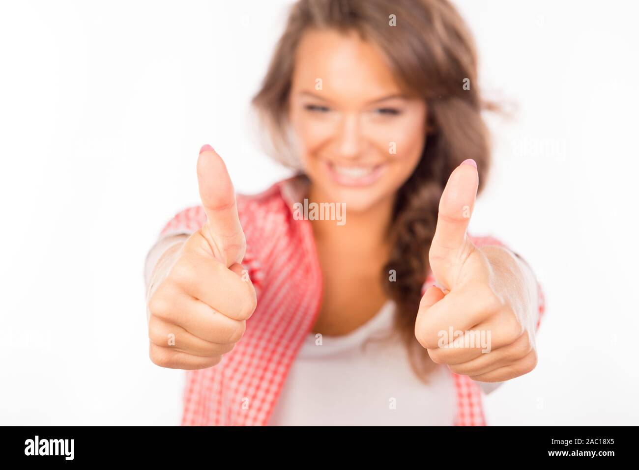 Happy cute girl showing thumbs up and smiling Stock Photo - Alamy