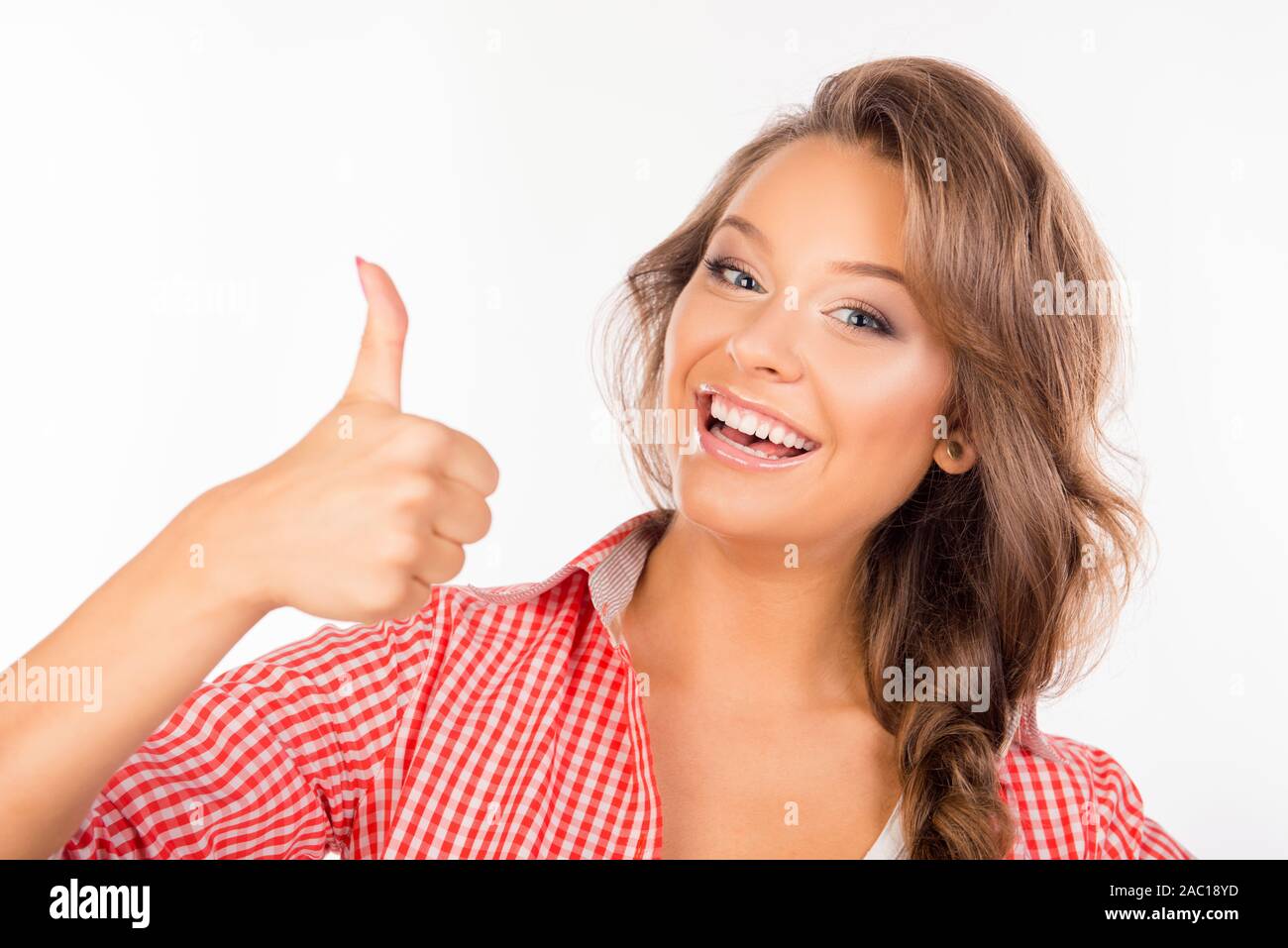 Happy cute girl showing thumb up and smiling Stock Photo - Alamy