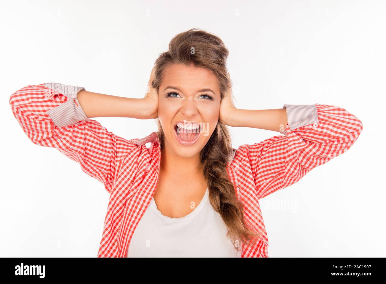 Young upset woman screaming and covering her ears Stock Photo - Alamy