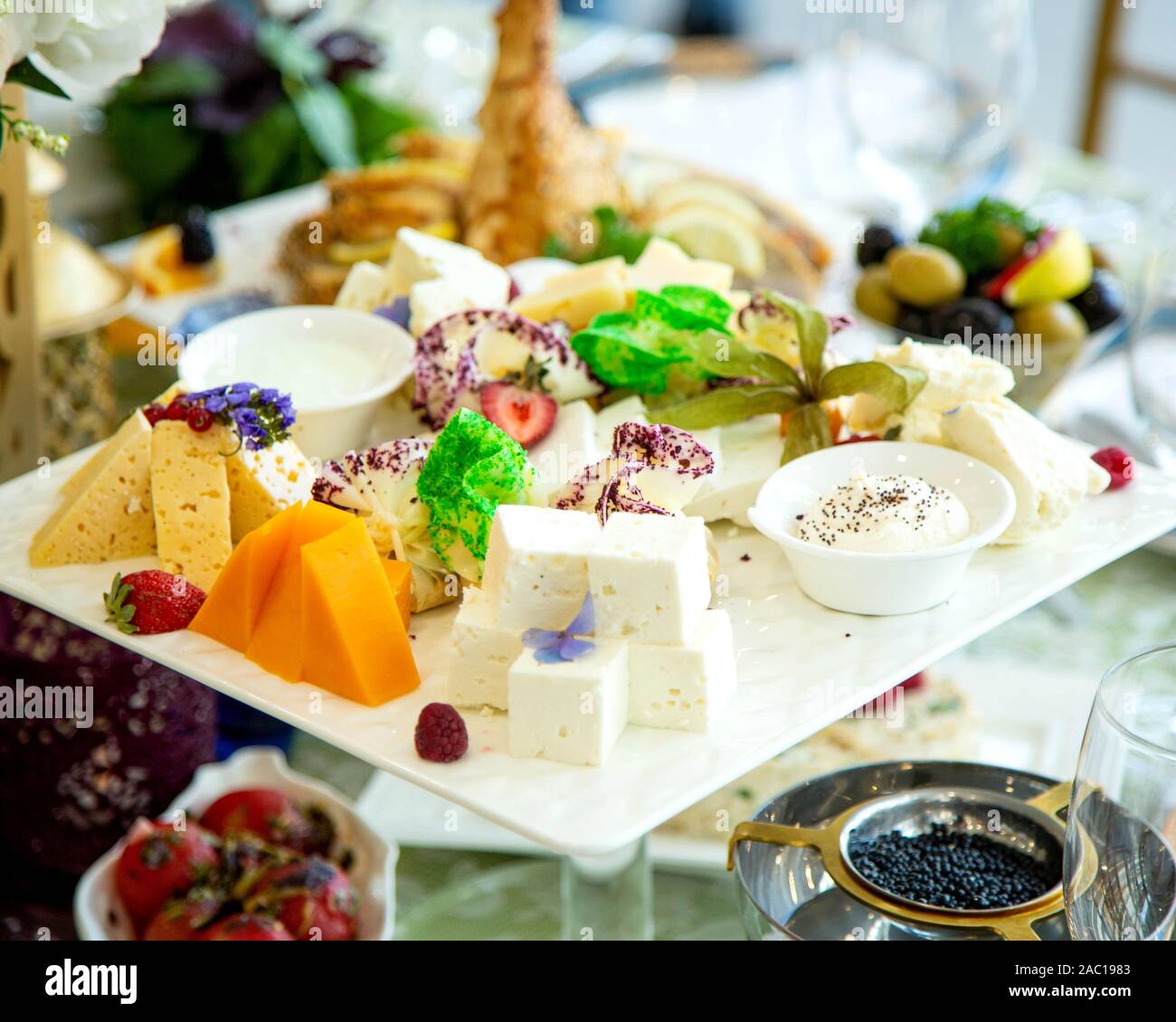 cheese platter with goat and white cheese, cheddar, parmesan and sauces ...