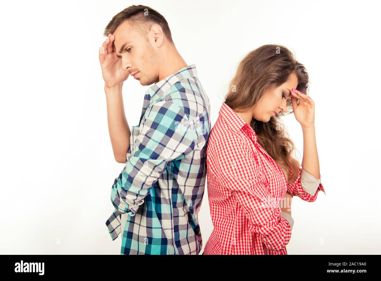 Couple standing back to back Stock Photo - Alamy