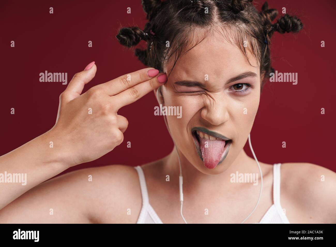 Closeup image of a young punk teenage girl listening music with ...