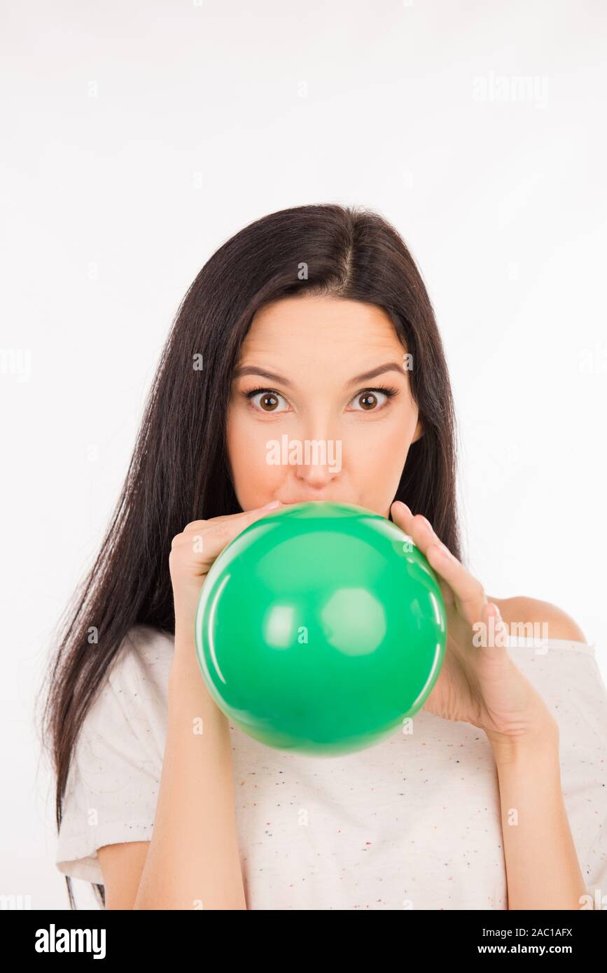 funny girl inflating a green balloon Stock Photo - Alamy