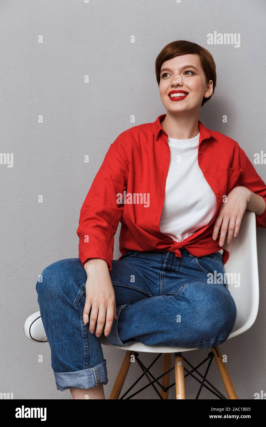 Image Of Brunette Young Woman Smiling While Sitting On Chair Isolated