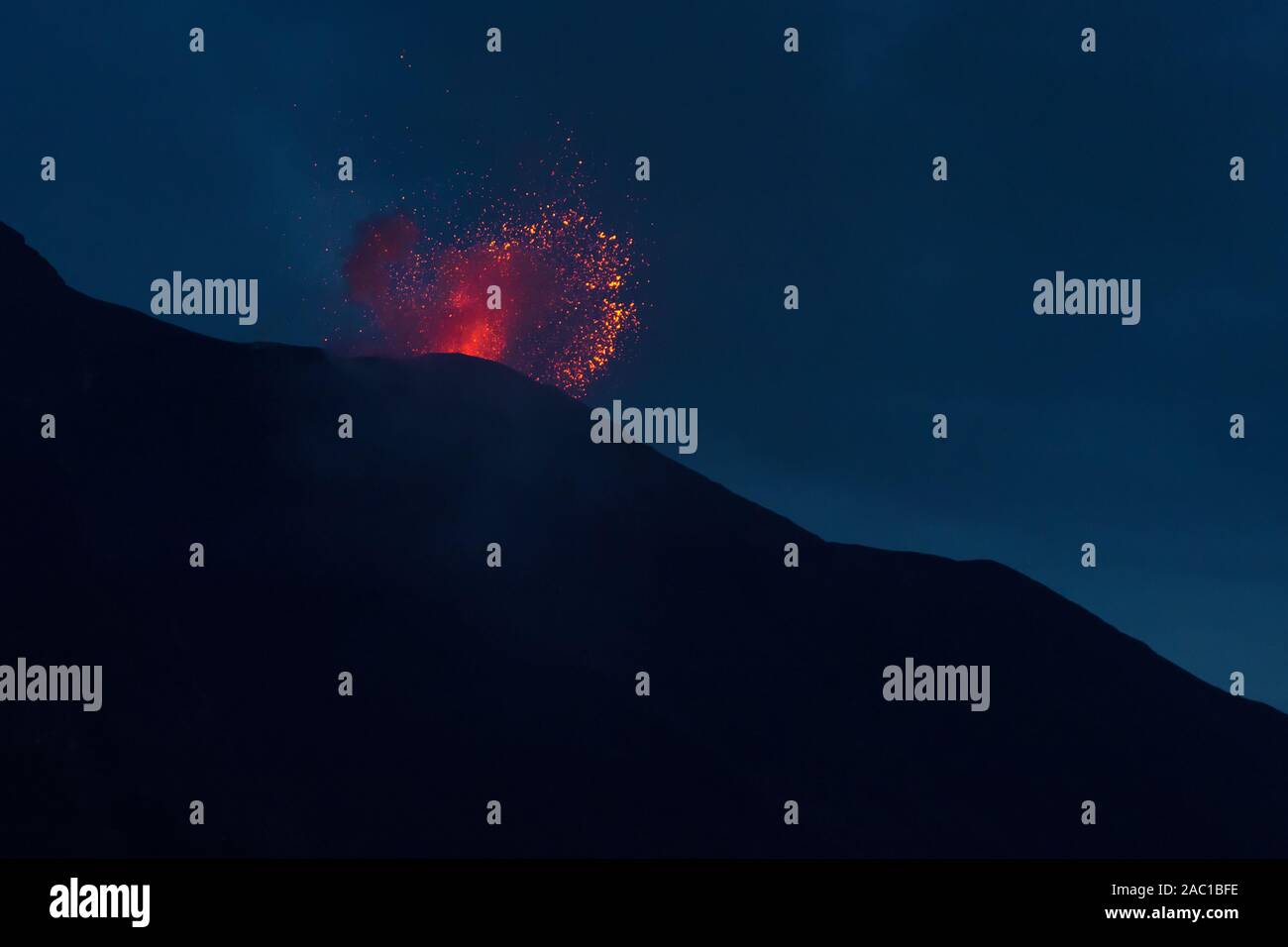 explosive eruption at dusk in one of the three craters of the active ...