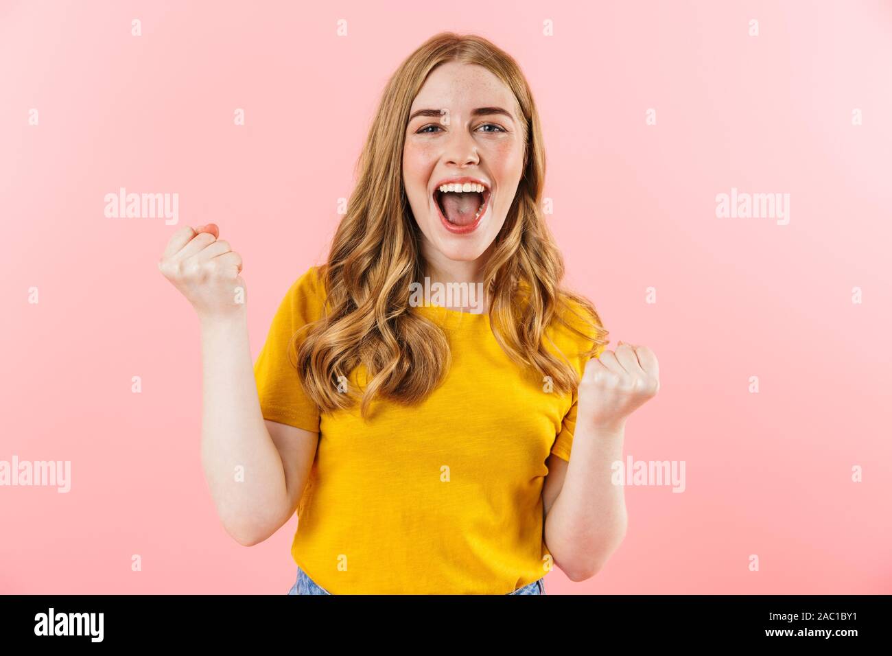 Image of a young positive happy screaming cute girl isolated over pink ...