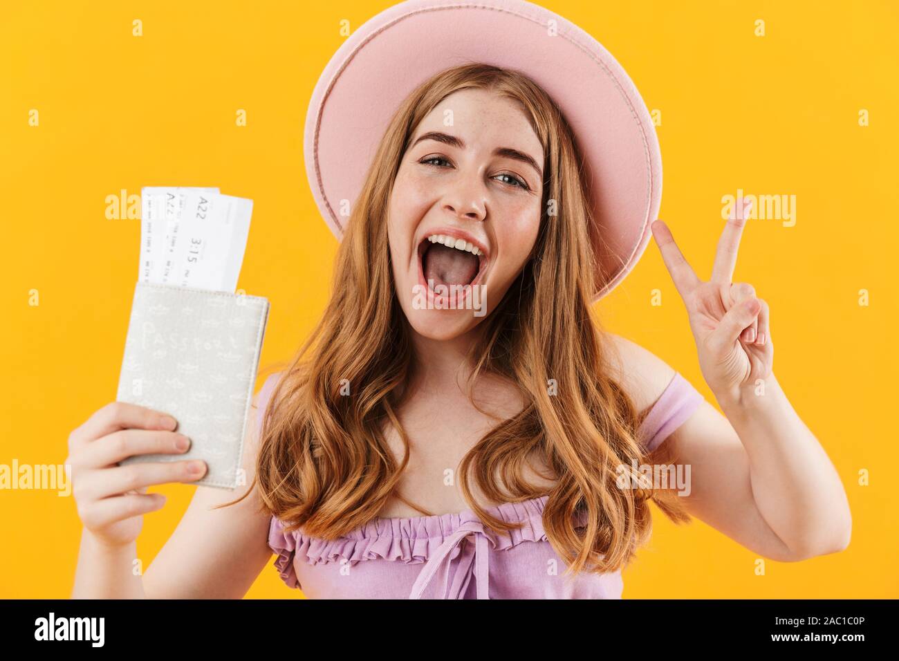 Image of a happy young cute teenage girl posing isolated over yellow ...