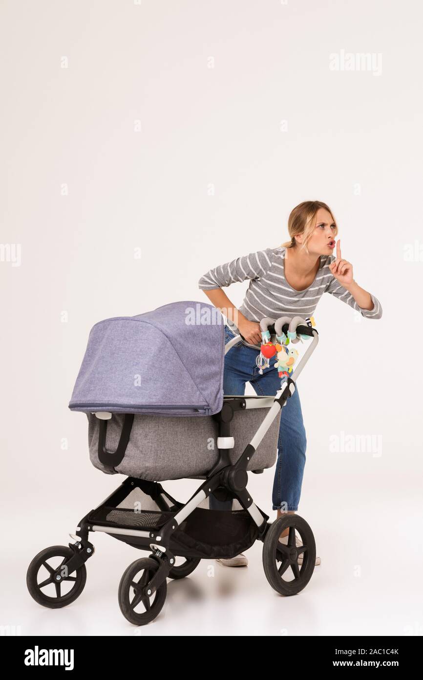 Image of a displeased young blonde woman mother walking with baby in ...