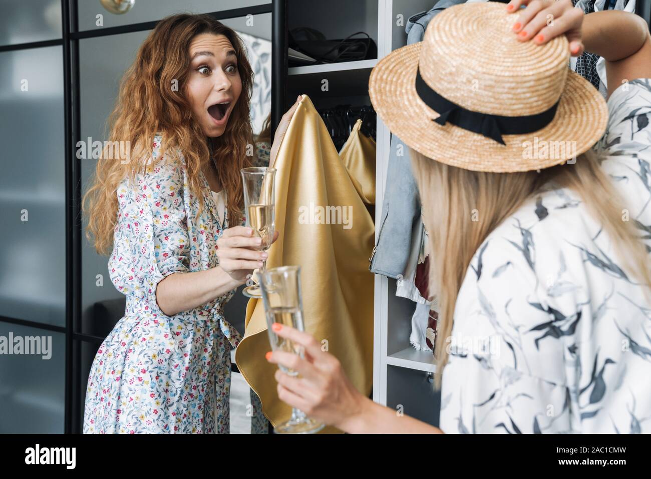 Photo of beautiful cute shocked surprised women at home drinking ...