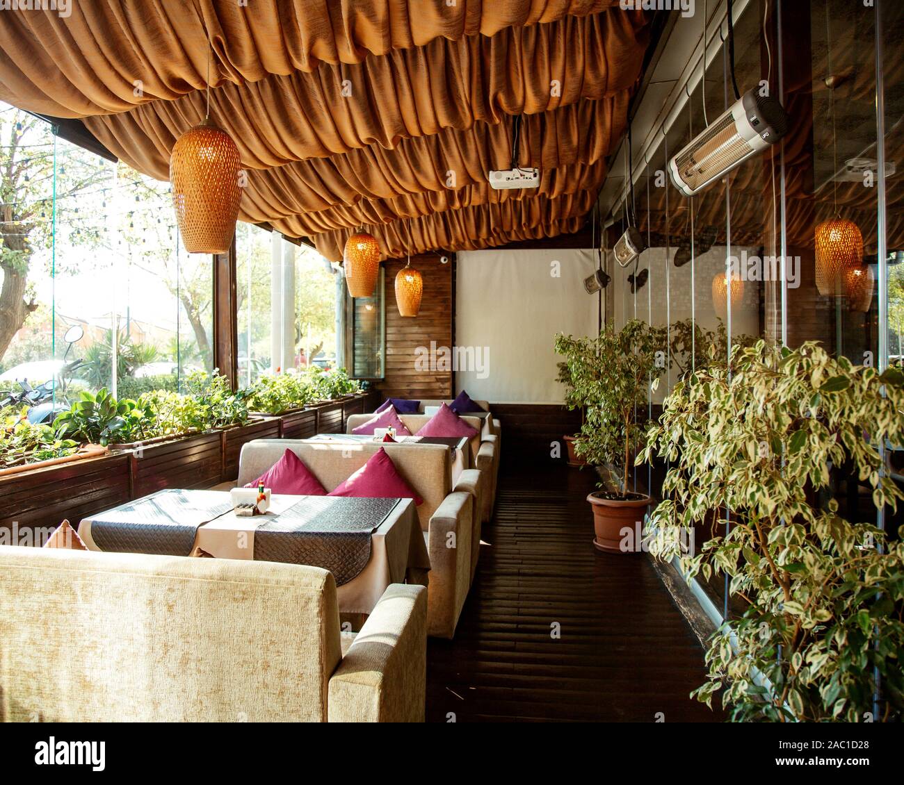 cafe terrace with glass windows and sofas Stock Photo - Alamy