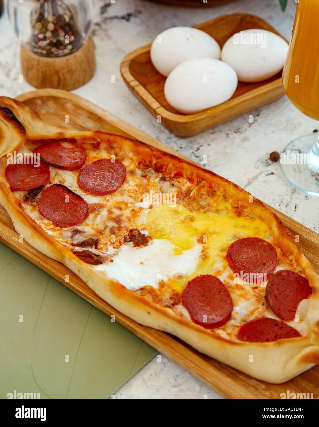 breakfast pide with pepperoni, cheese and eggs Stock Photo - Alamy
