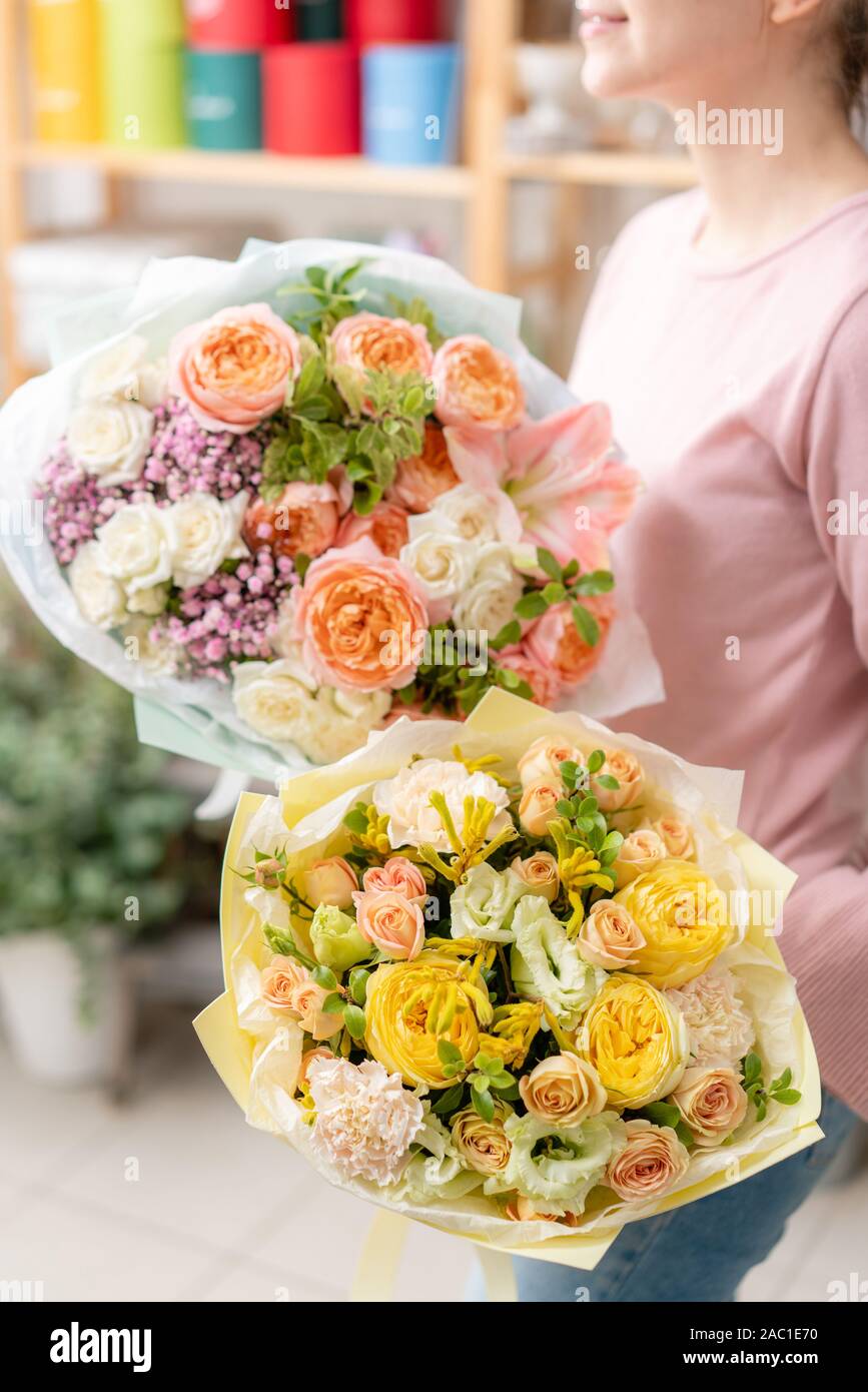 European floral shop. Two Beautiful bouquets of mixed flowers in womans ...