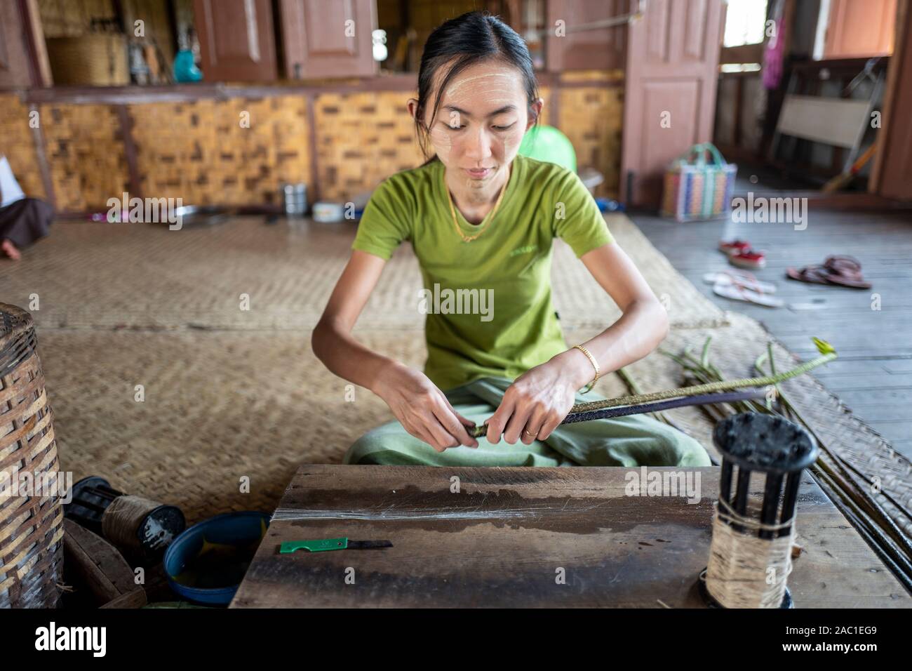 Traditional lotus plant weaving handicraft worker on Inle Lake in ...
