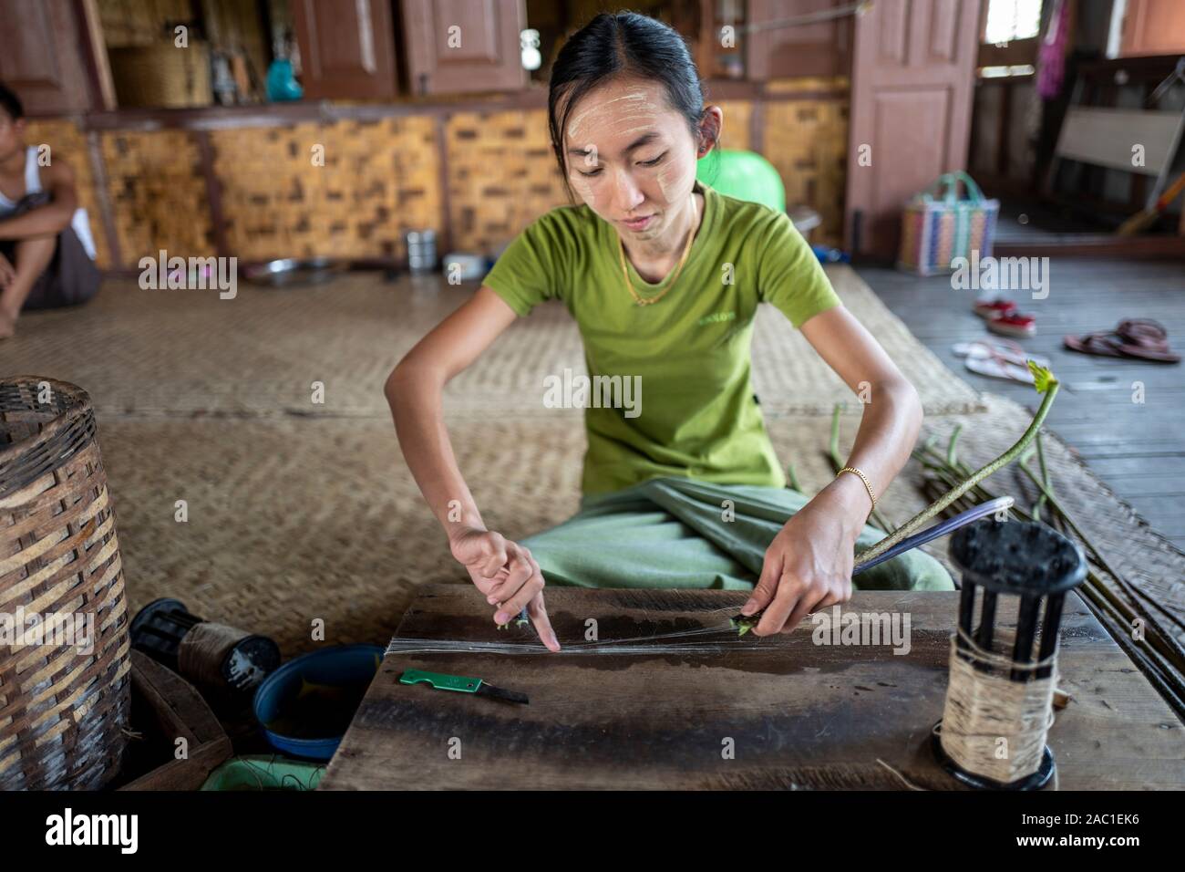 Traditional lotus plant weaving handicraft worker on Inle Lake in ...