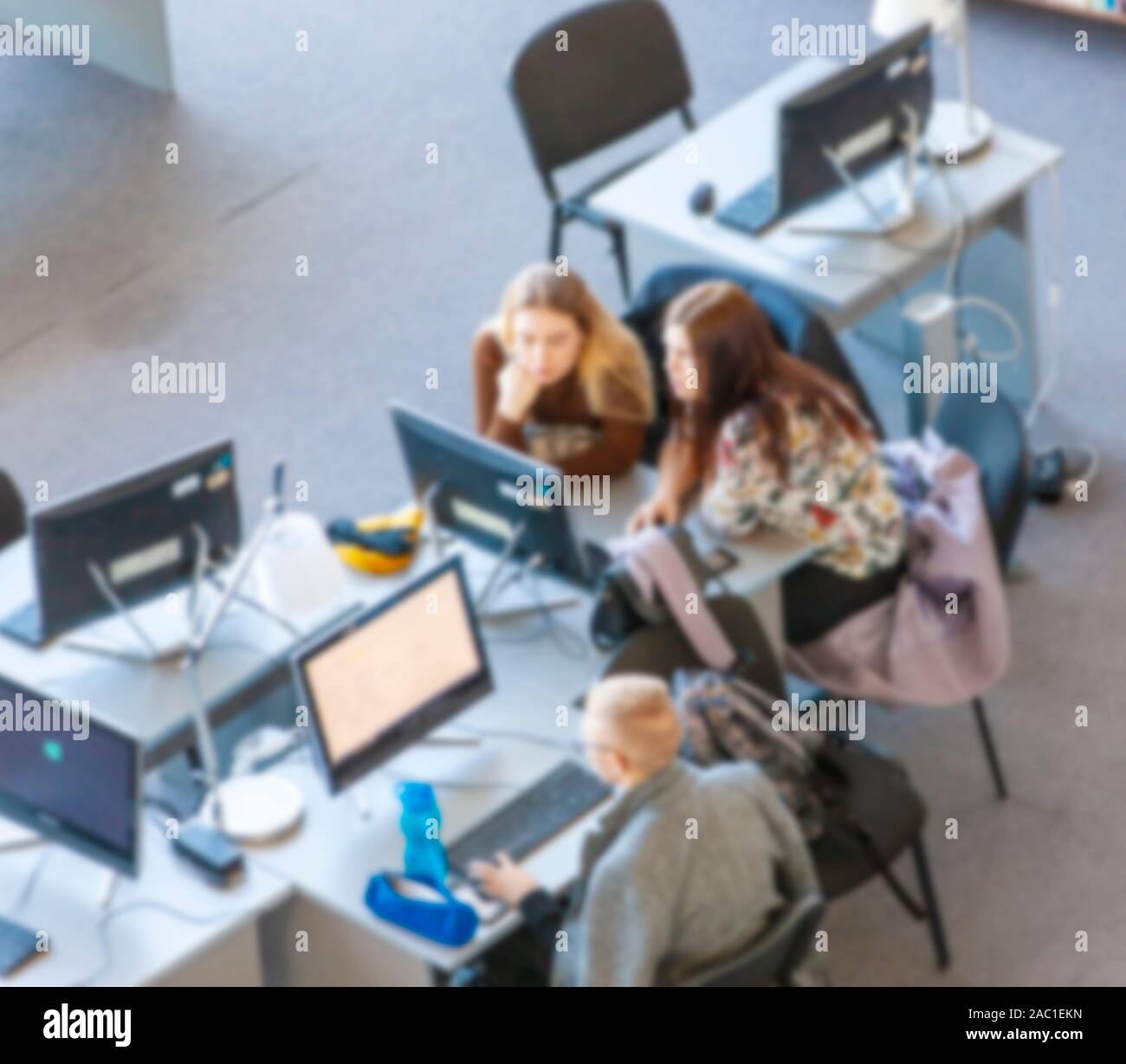 the blured student for the computer behind the Desk in the library ...