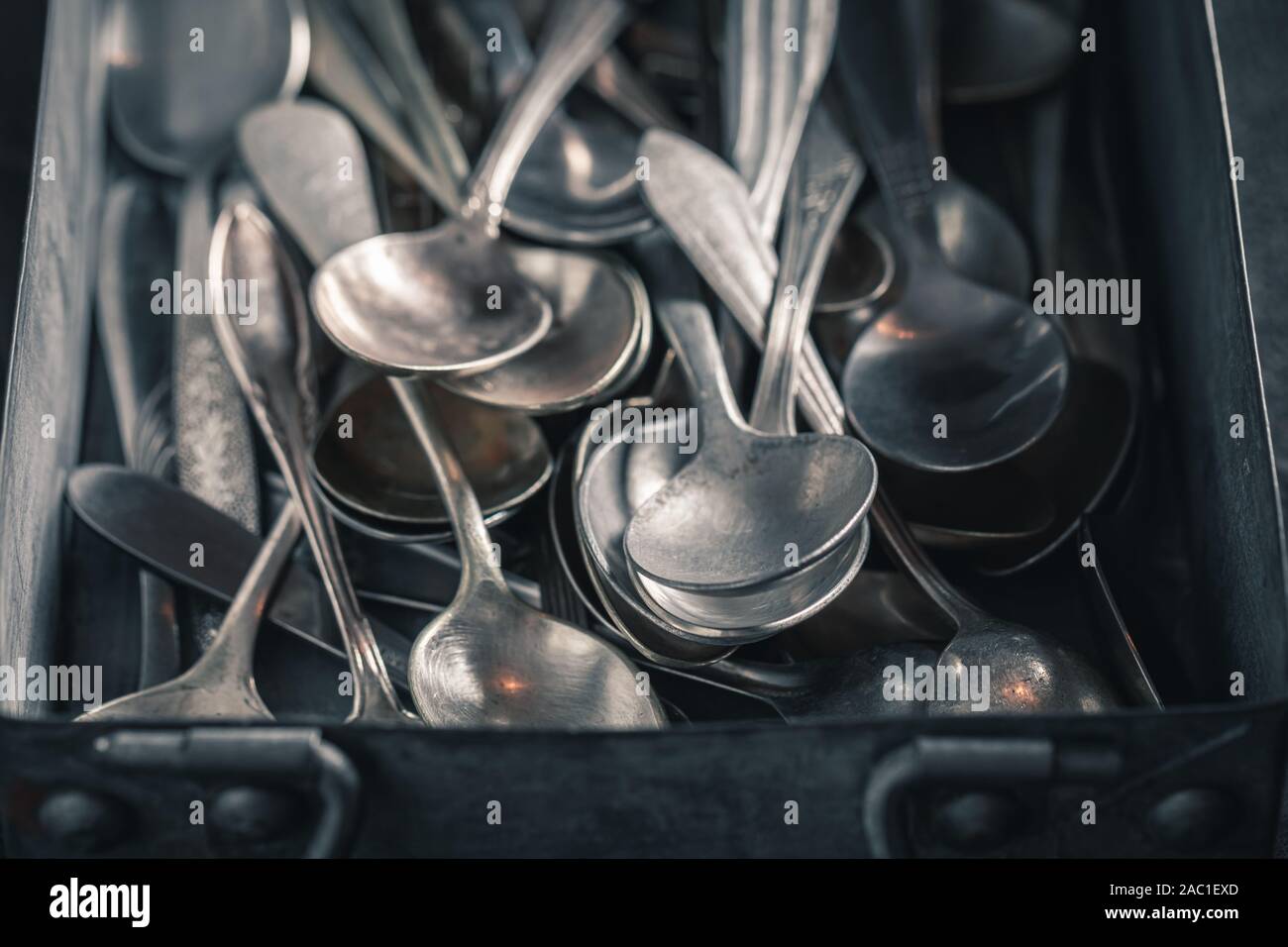 Closeup of stack of spoons in a metal box Stock Photo - Alamy